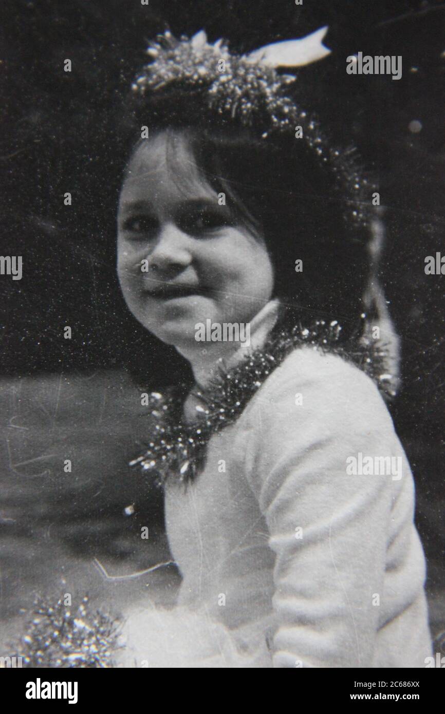 Fine 70s vintage black and white lifestyle photography of elementary school kids putting on a ...