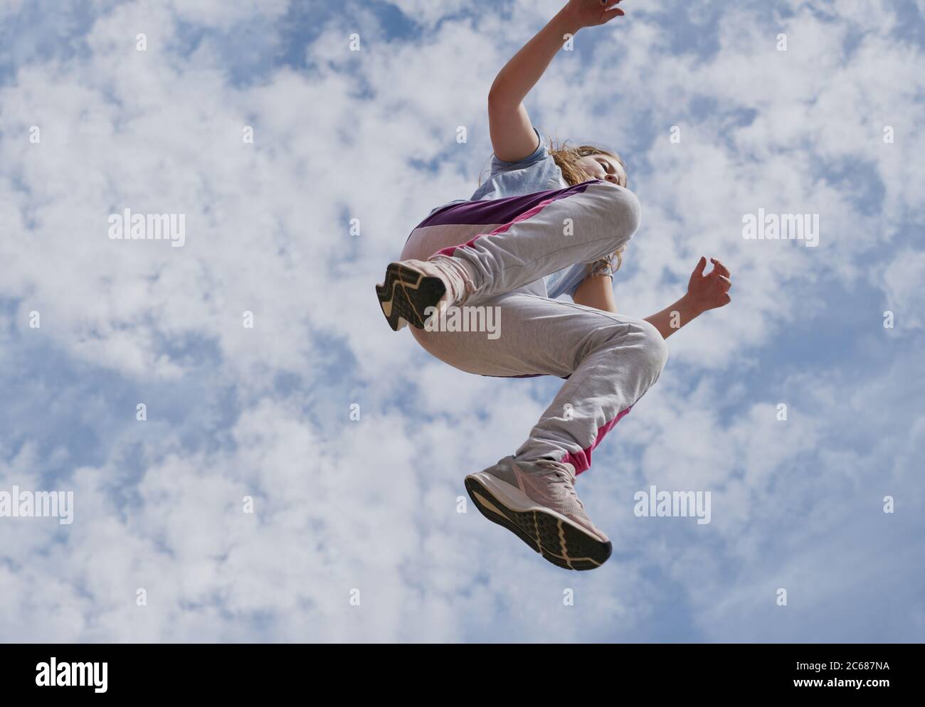 From below a girl in slippers jumping with the bottom of the sky Stock ...