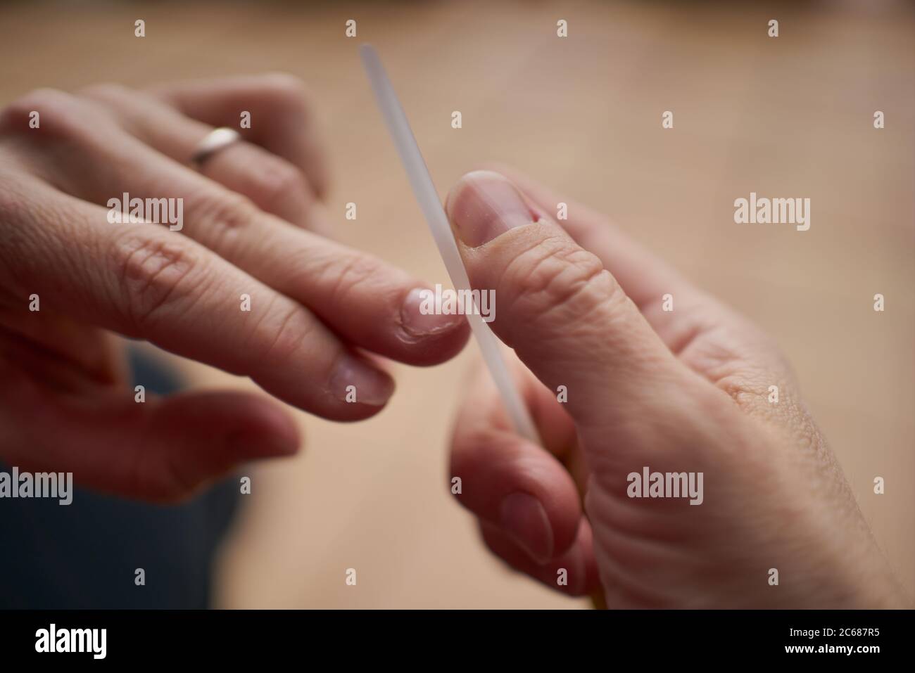 From above crop person cutting nails with clipper while doing manicure ...