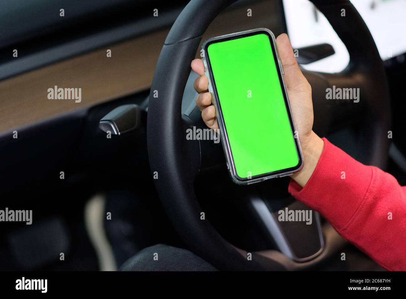 close up one man showing green screen phone inside car. blurred ...
