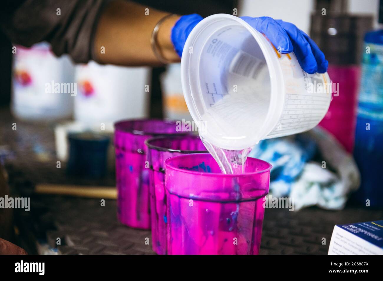 Female resin artist mixing, pouring and measuring Stock Photo - Alamy