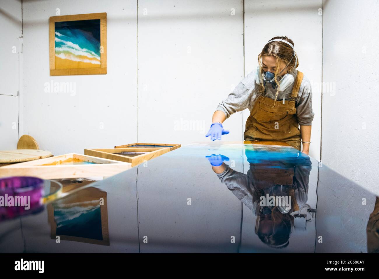 Female resin artist using hands to perfect artwork Stock Photo - Alamy
