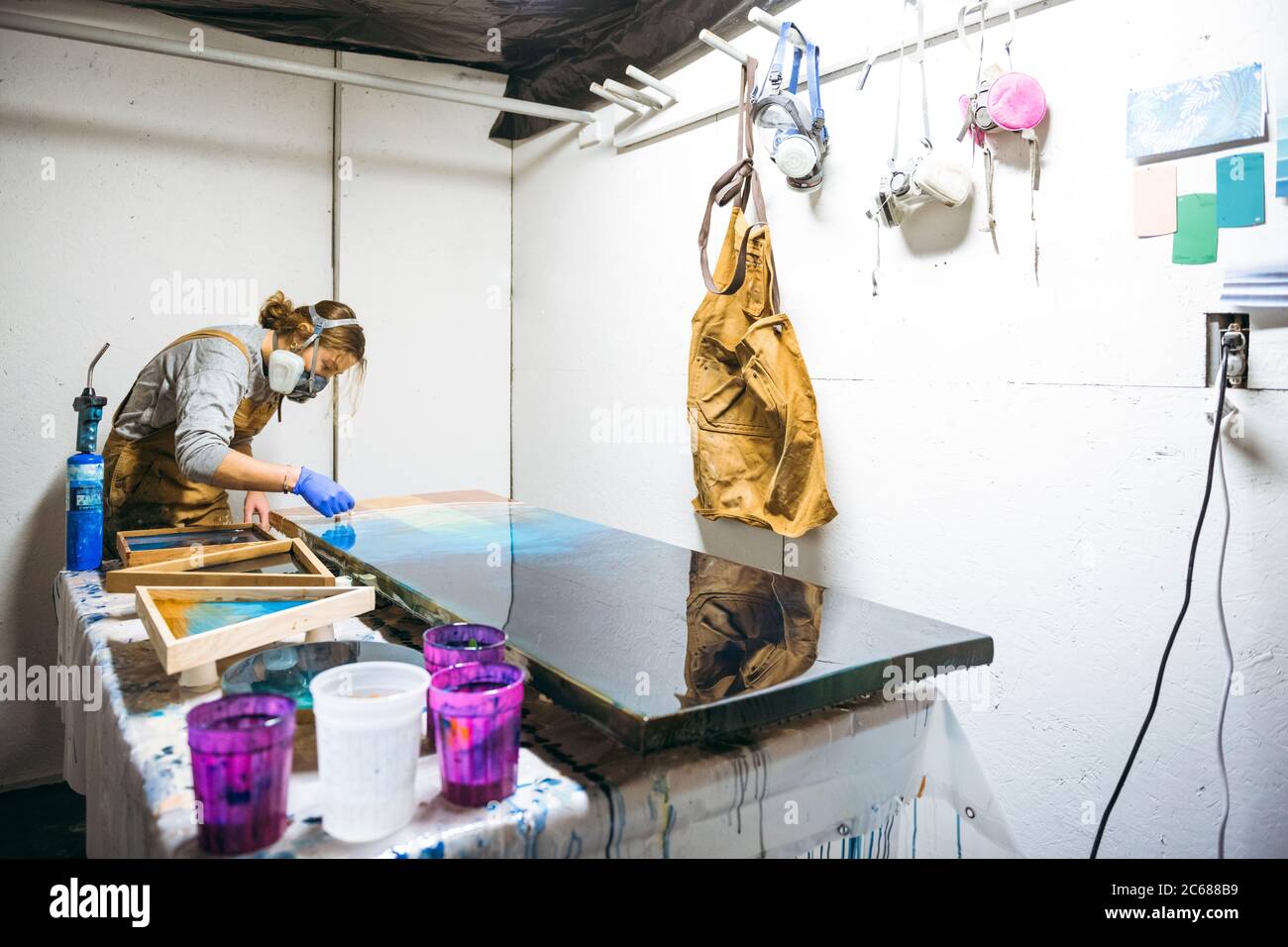 Female resin artist perfecting reflective artwork Stock Photo - Alamy