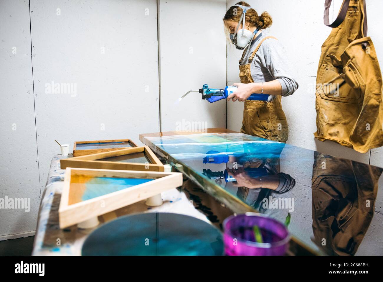 Female resin working in homemade studio with blowtorch Stock Photo - Alamy
