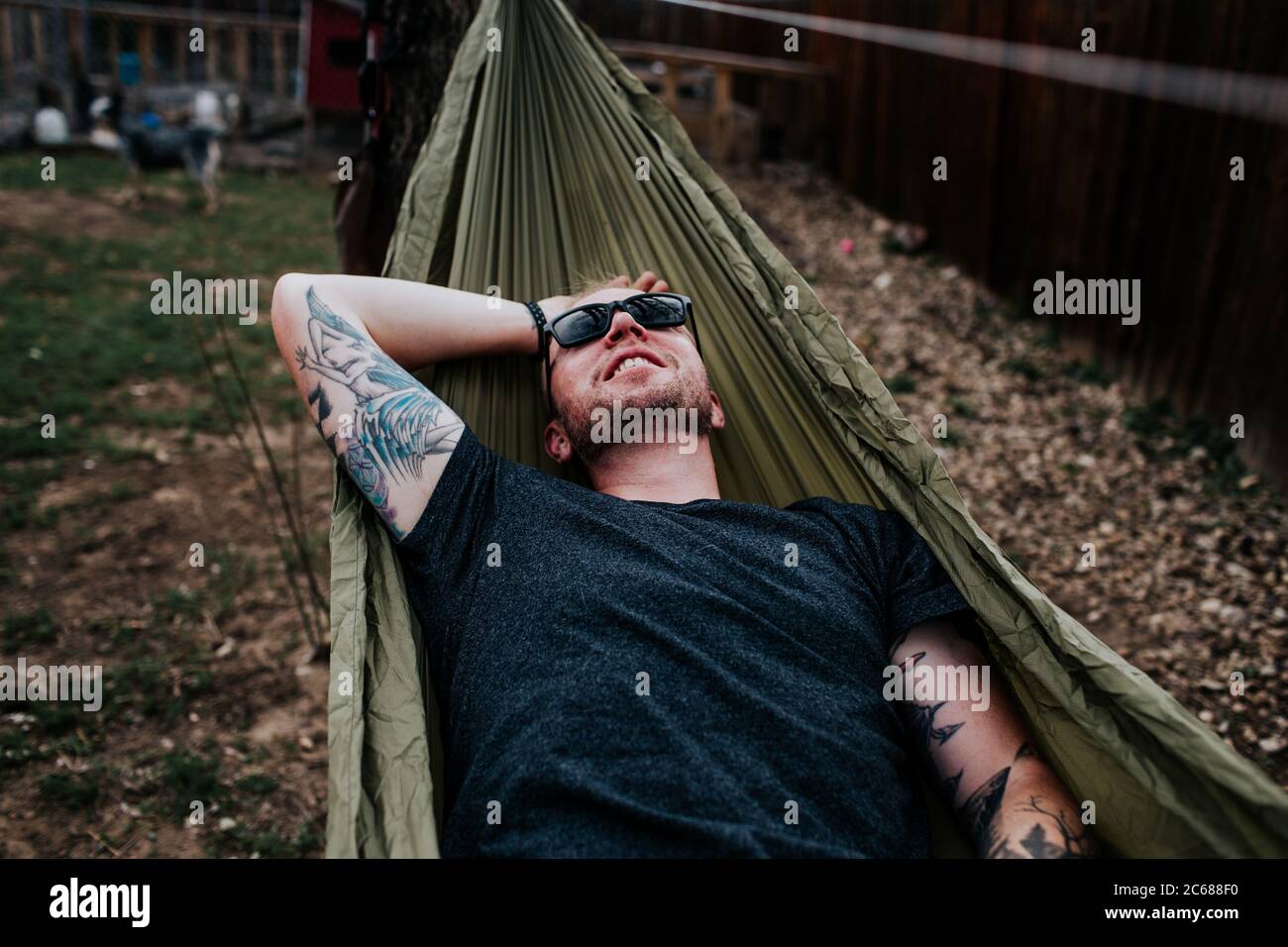 Happy Man relaxing in hammock Stock Photo - Alamy
