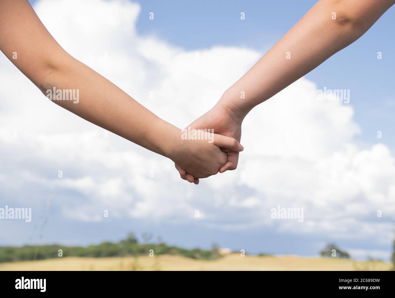 Helping hand between two brothers in the background of the blue sky ...