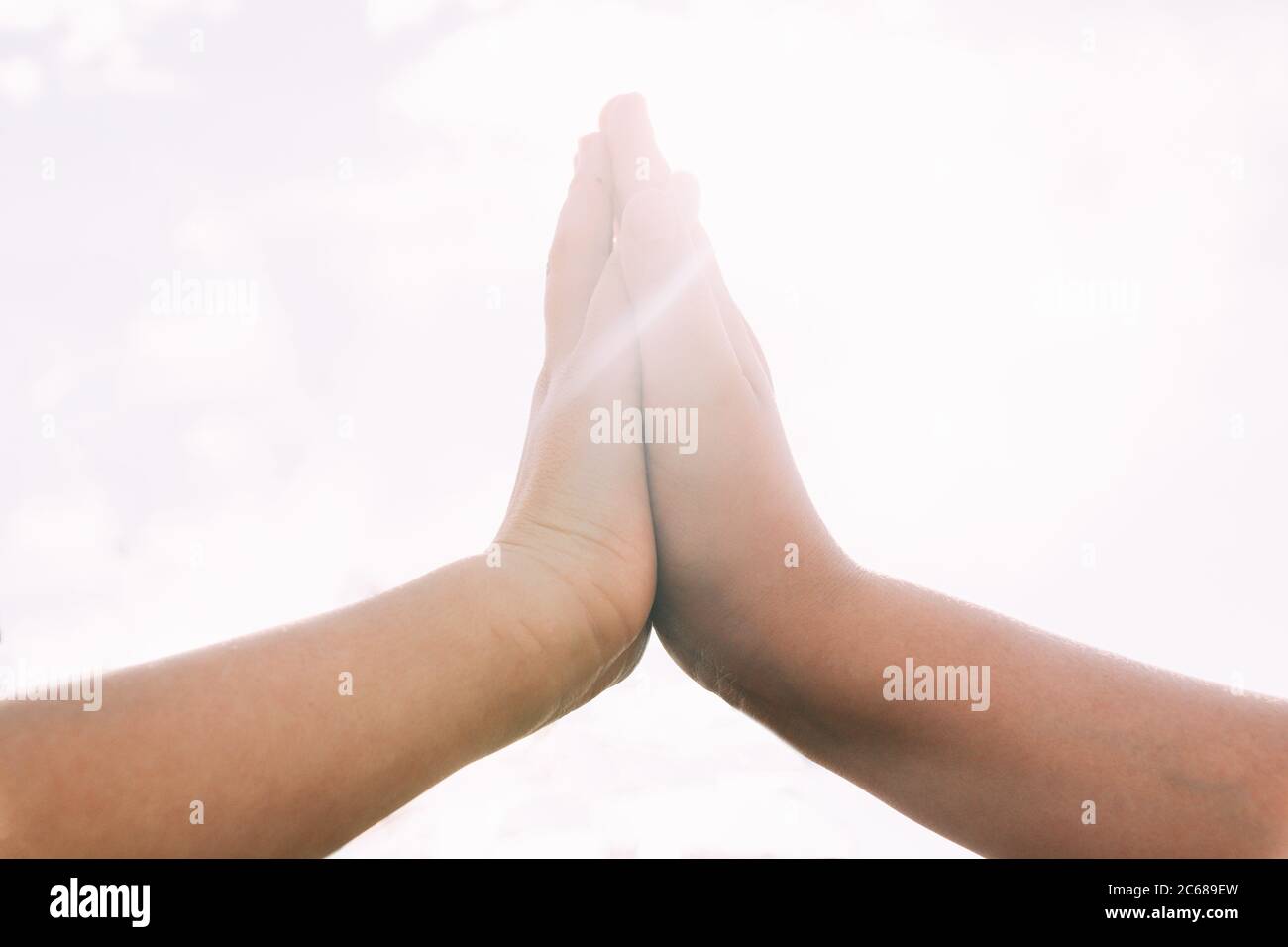 Union of hands two sisters in the background of the blue sky, Family ...