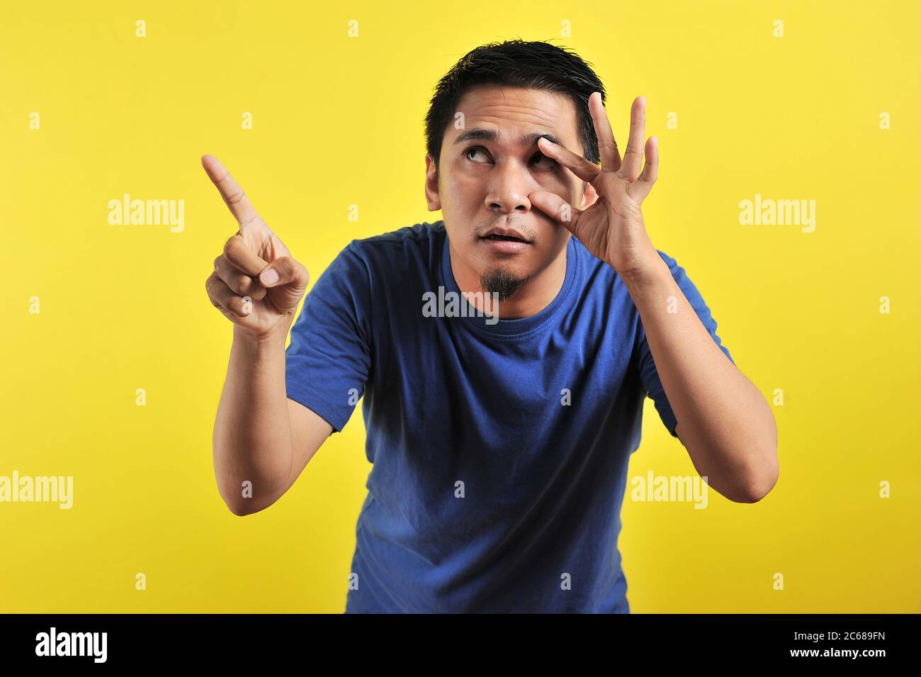 Isolated man mouth open pointing hi-res stock photography and images ...