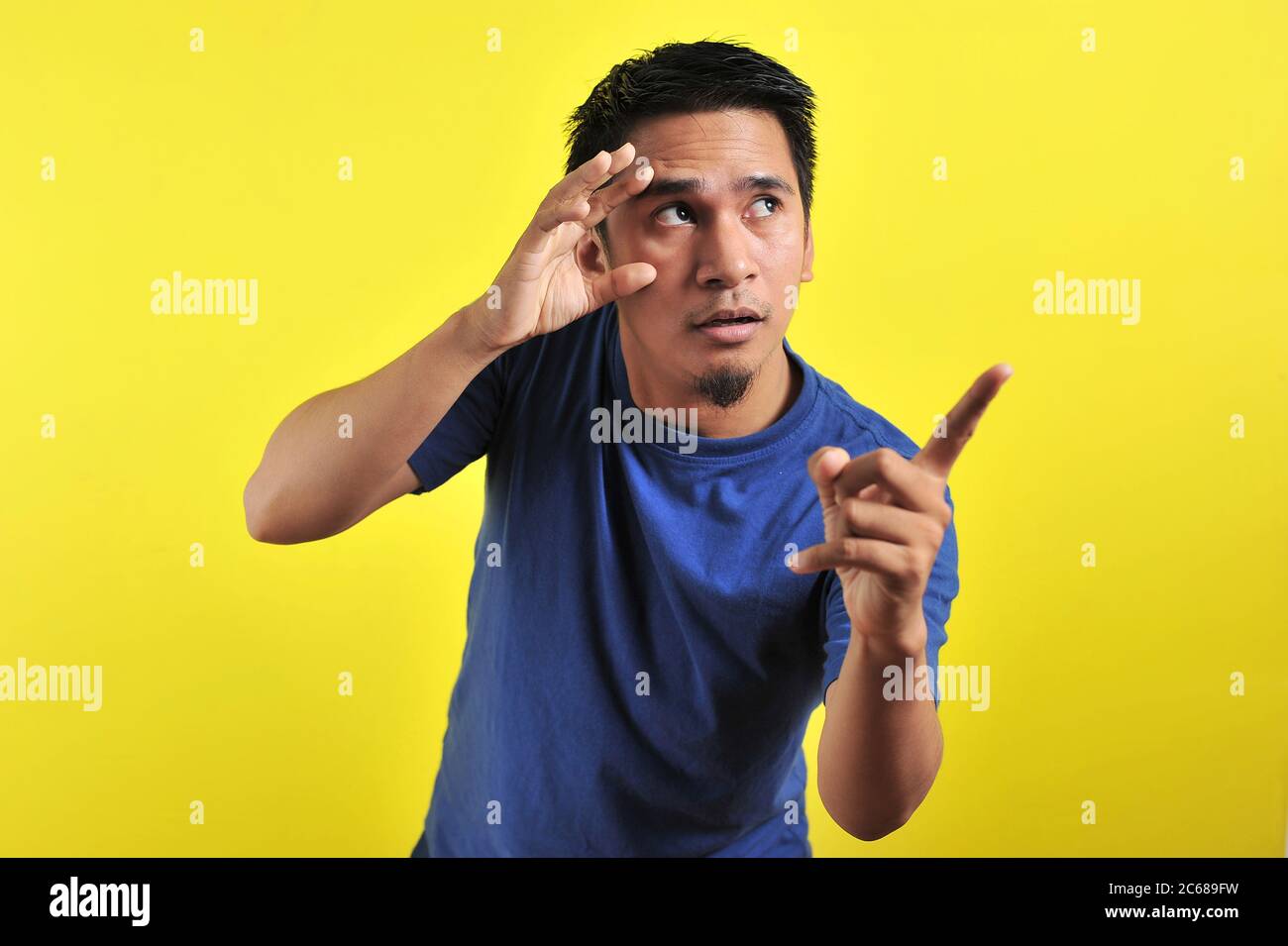 Isolated man mouth open pointing hi-res stock photography and images ...