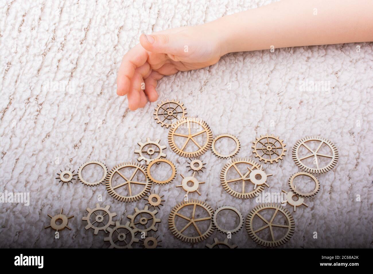 Hand holding gear wheels as the concept of mechanism Stock Photo - Alamy