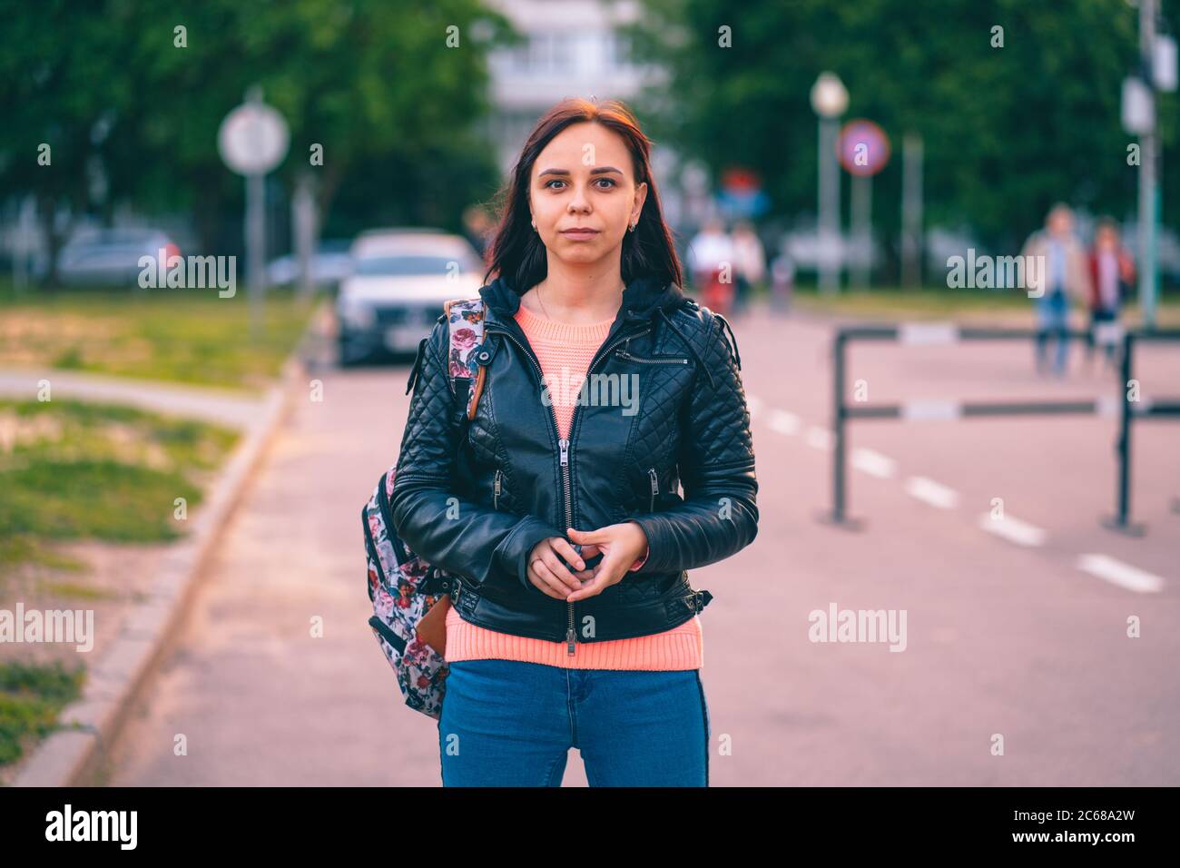 Portrait of young woman on street. Beautiful female in casual clothes ...