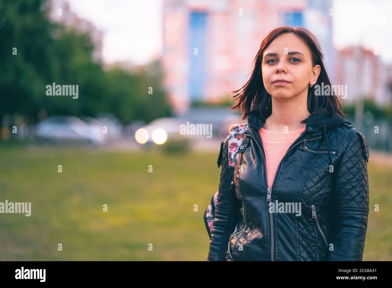 Portrait of young woman on street. Beautiful female in casual clothes ...