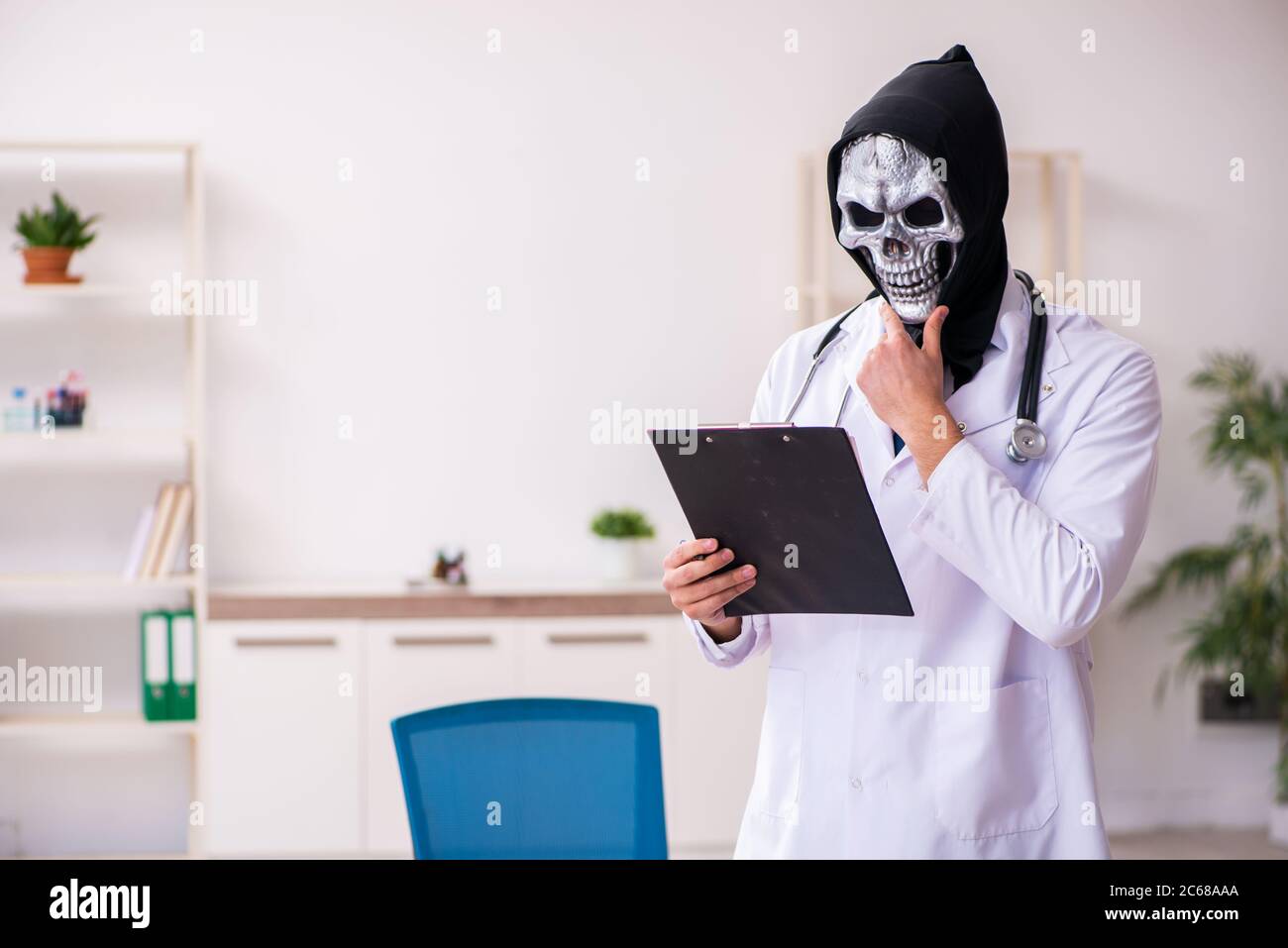 Male devil doctor working in clinic Stock Photo - Alamy