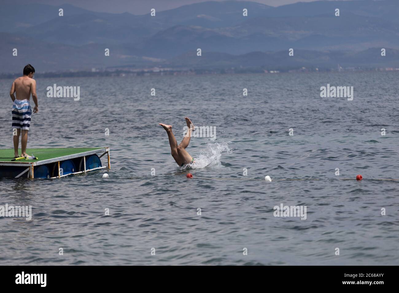 Boy jumping off pier hi-res stock photography and images - Alamy
