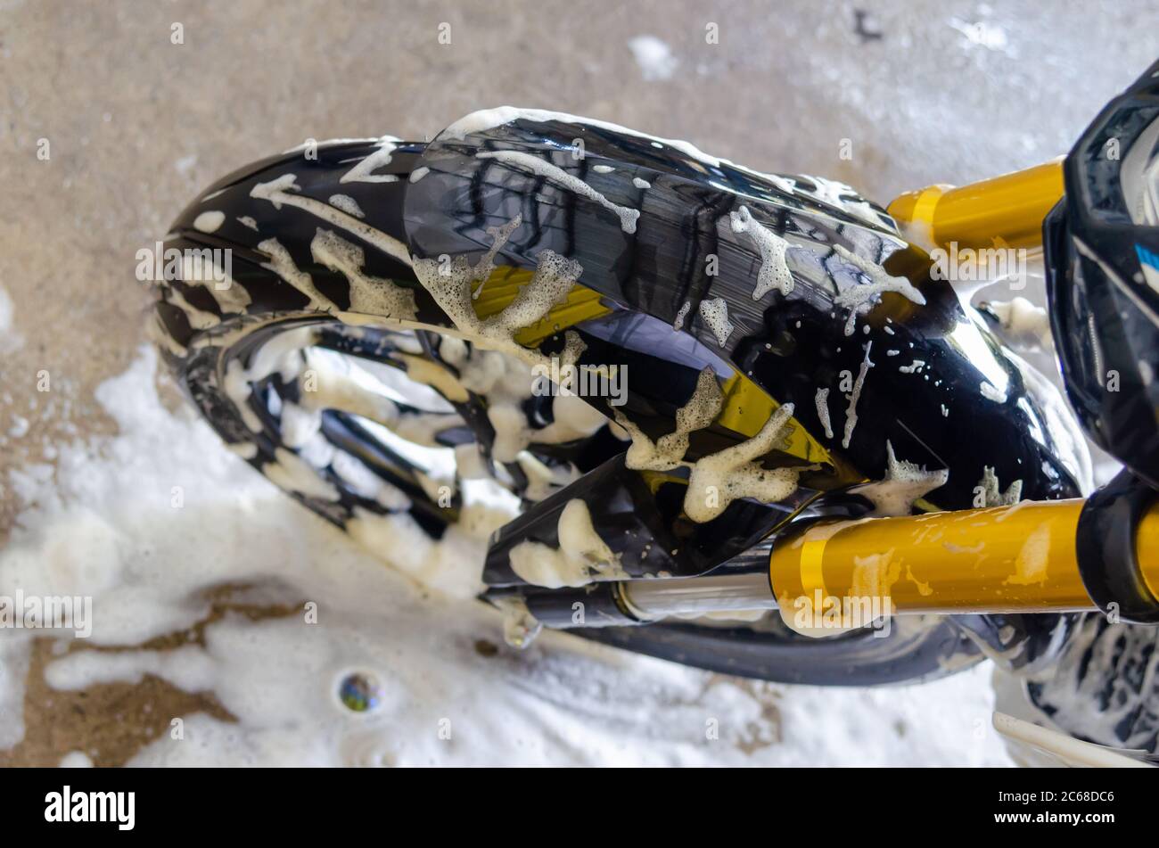 Bubble foam cleaning motorcycle wash Stock Photo - Alamy