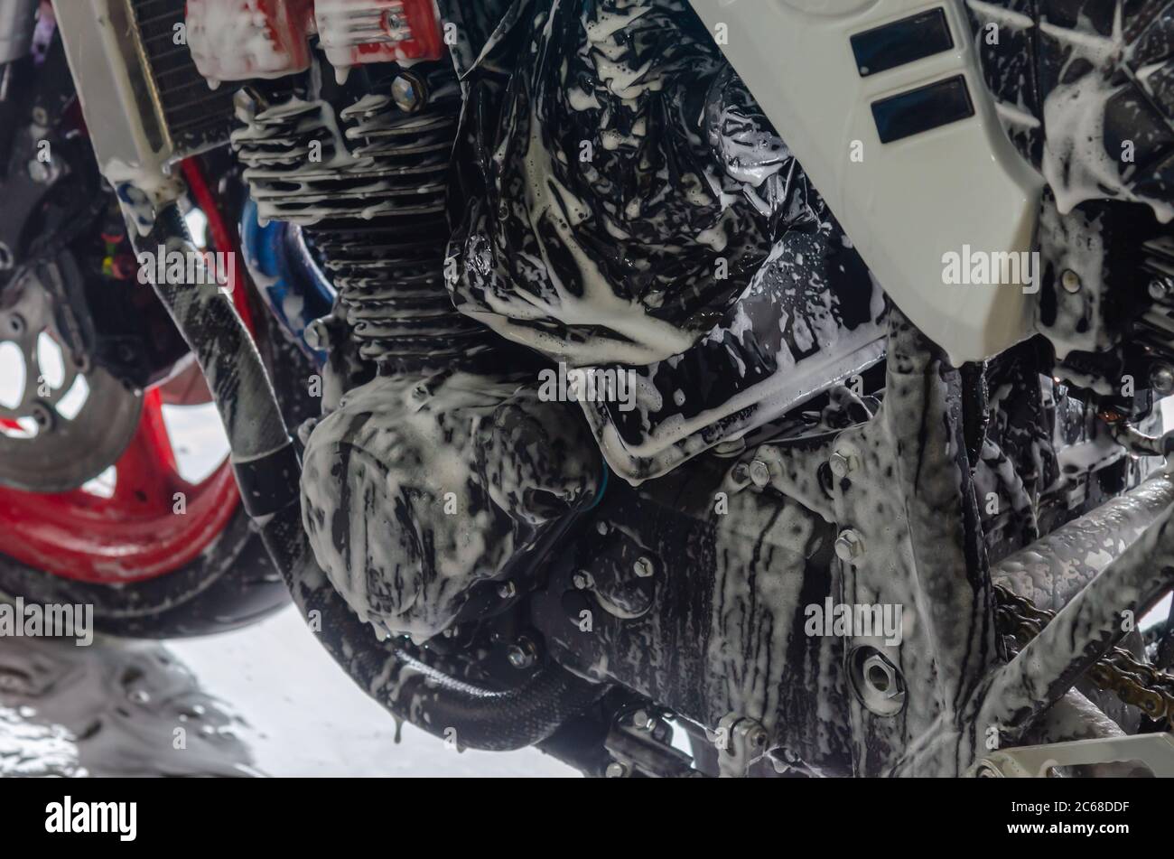 Bubble foam cleaning motorcycle wash Stock Photo - Alamy