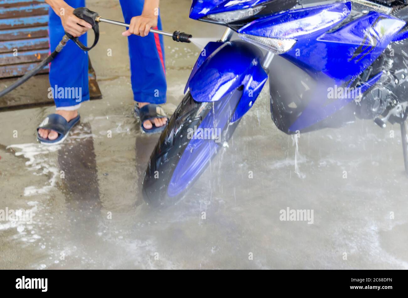 High-pressure water gun washing a motorcycle Stock Photo - Alamy