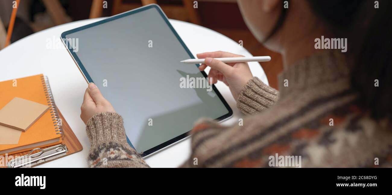 Close up view of female college student doing assignment with vertical ...