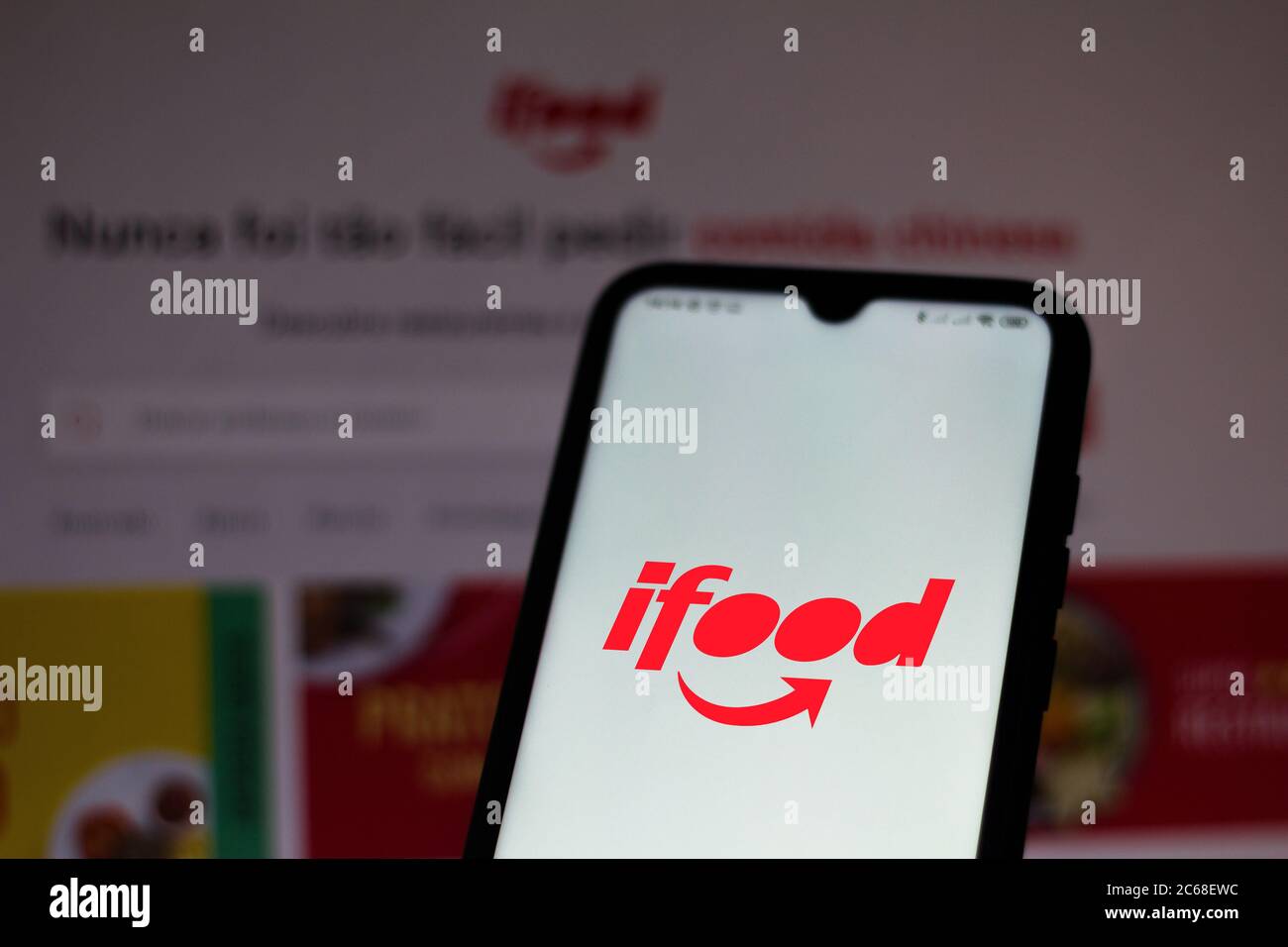 In this photo illustration the iFood logo seen displayed on a ...