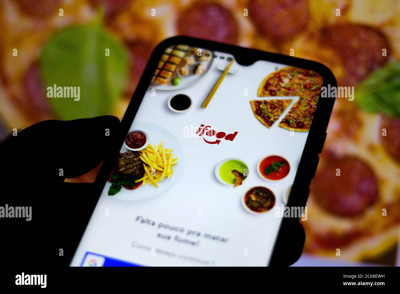 In this photo illustration the iFood logo seen displayed on a ...