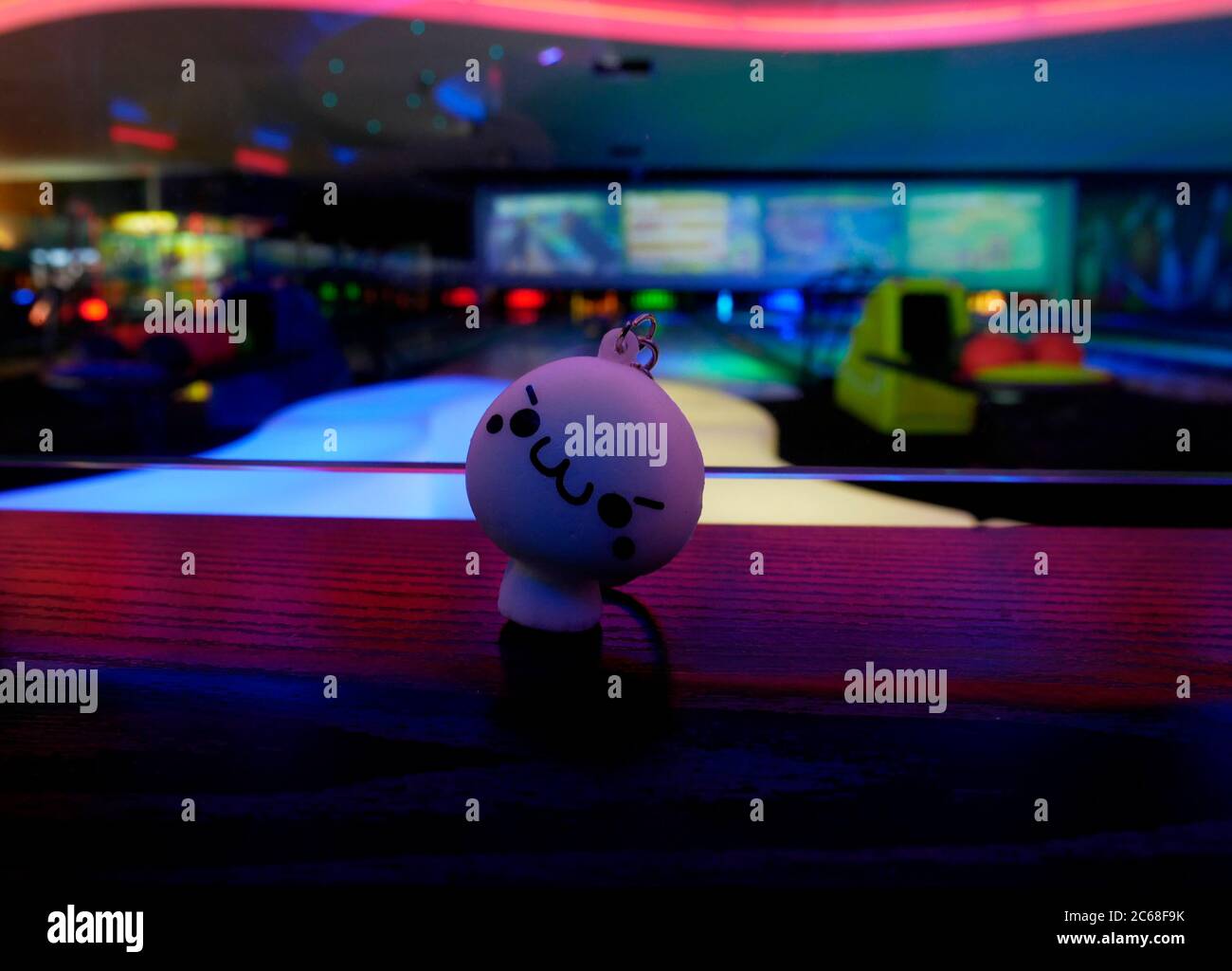 small Japanese style toy, with the lights of a modern amusement arcade ...