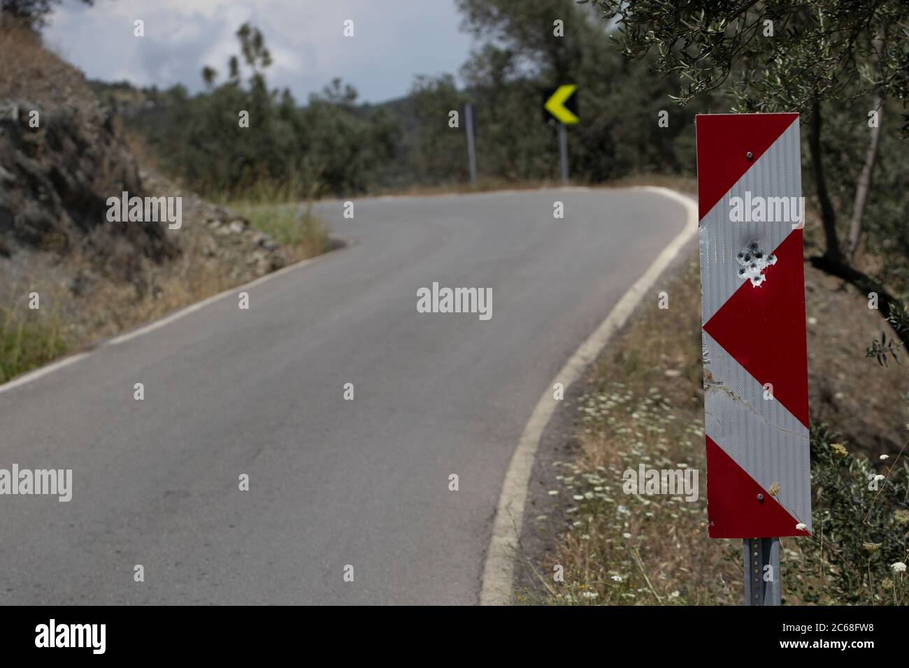 Red road traffic sign full of bullet holes. Close up Stock Photo - Alamy