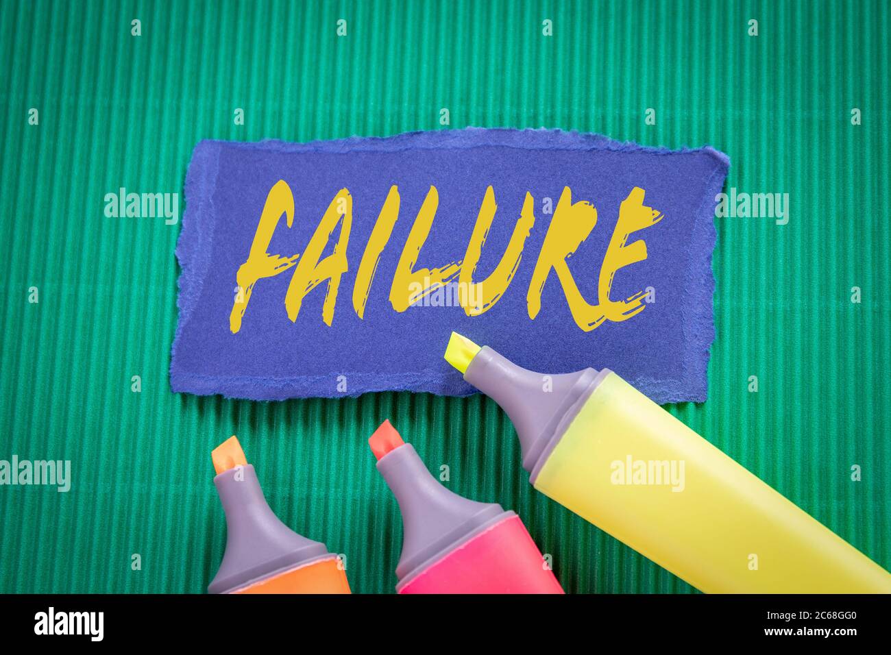 FAILURE. Business concept. Text on torn, colored paper on corrugated ...