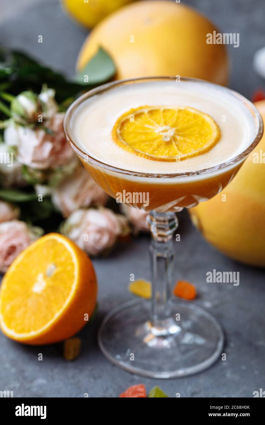Orange cocktail with a slice of orange on a black concrete background ...
