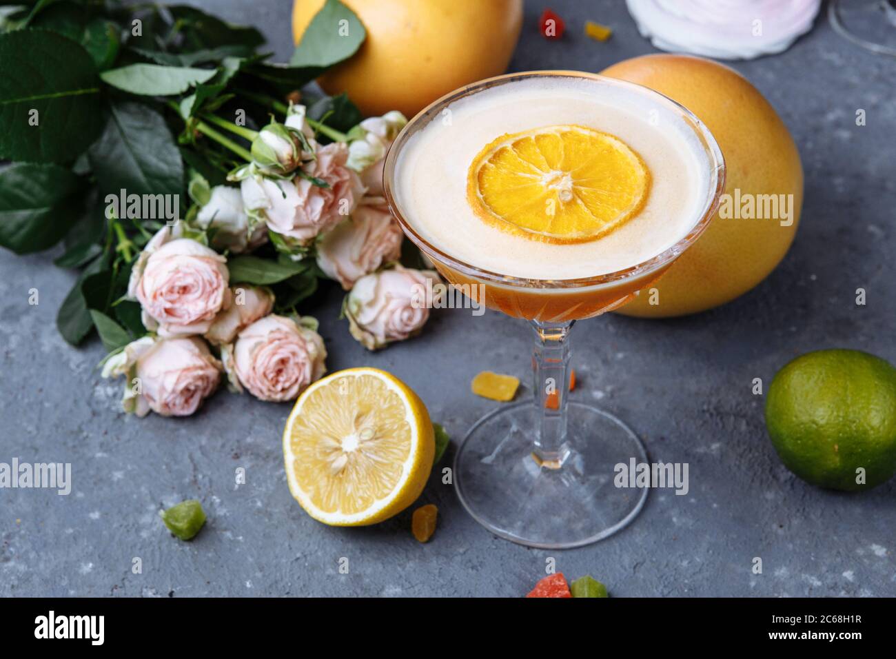 Orange cocktail with a slice of orange on a black concrete background ...