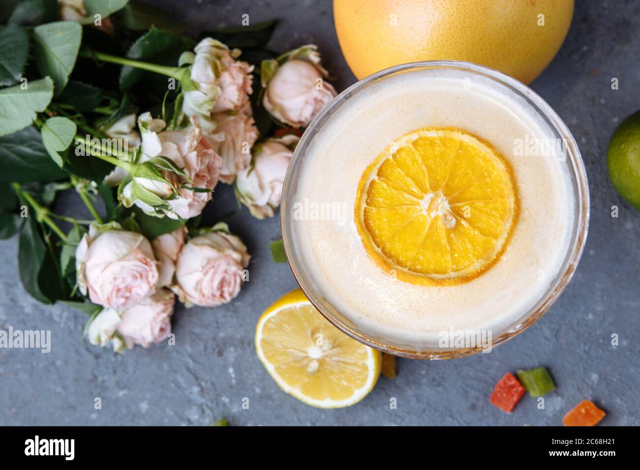 Orange cocktail with a slice of orange on a black concrete background ...