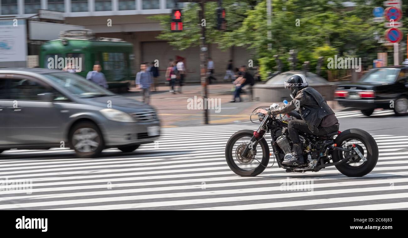 Man riding a motorcycle in the street of Shibuya, Tokyo, Japan Stock ...