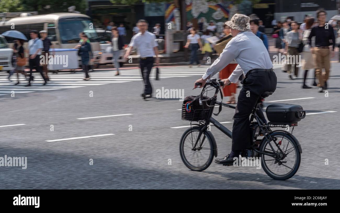 Man riding bicycle in the street of Shibuya, Tokyo, Japan Stock Photo ...