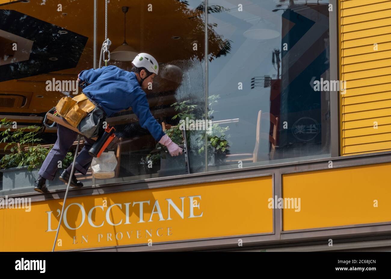 Window cleaners hanging on rope, Tokyo, Japan Stock Photo - Alamy