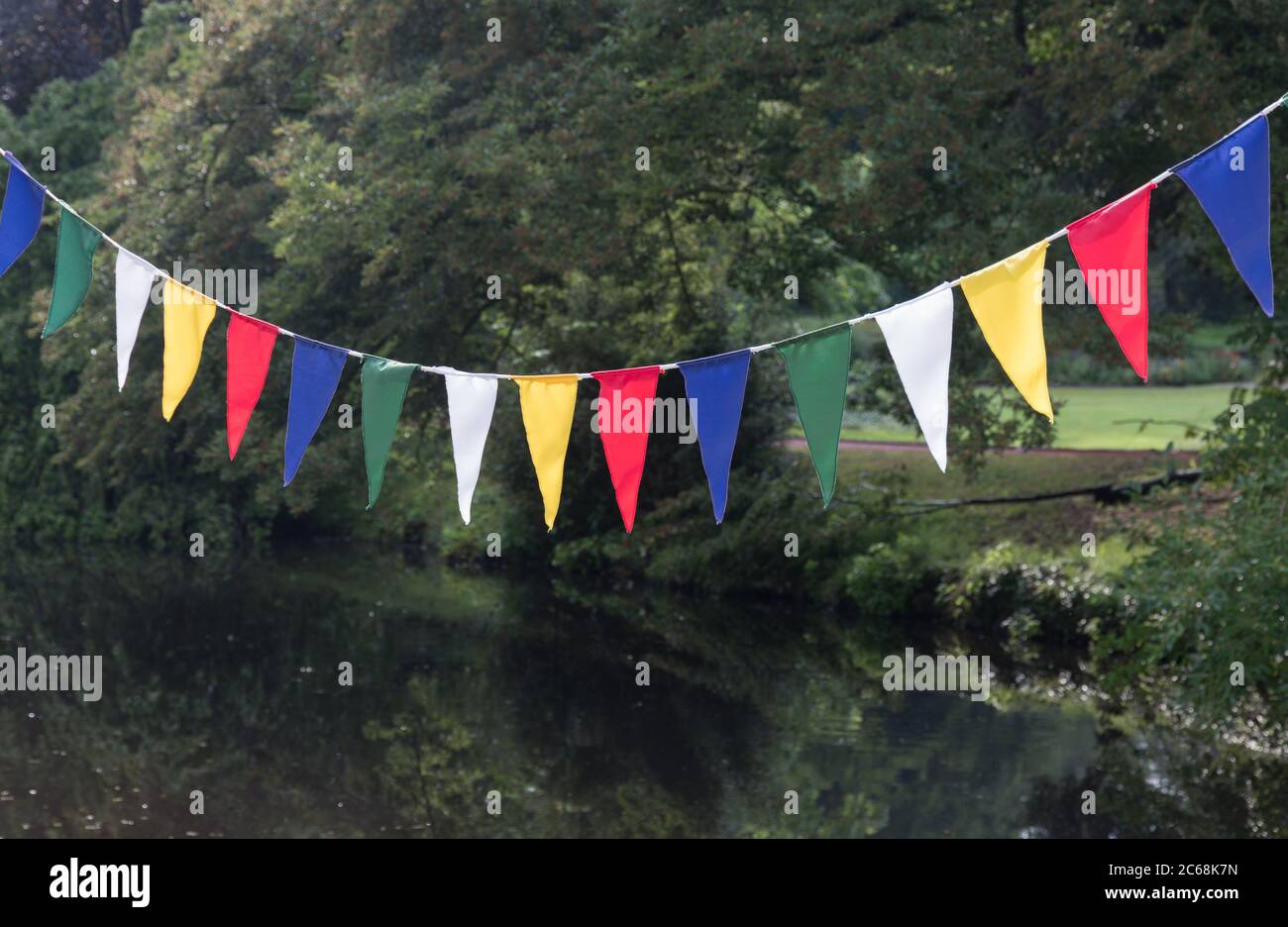 colorful decoration with triangles in a line above a river Stock Photo ...