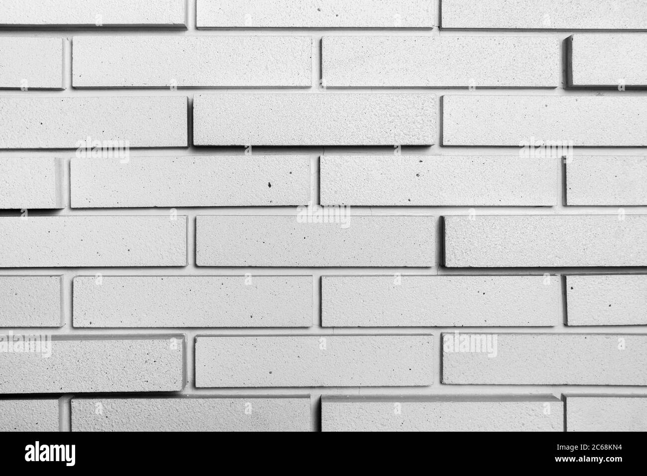 Irregular brick arrangement. On the wall. In black and white Stock ...