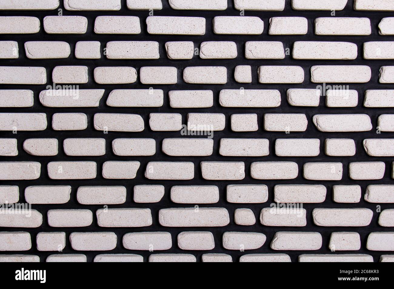 Irregular brick arrangement. On the wall. In black and white Stock ...