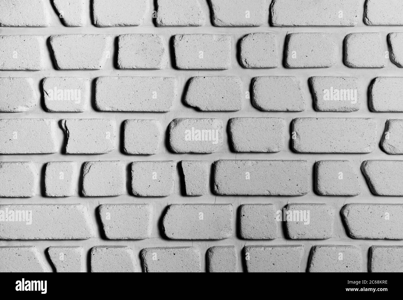 Irregular brick arrangement. On the wall. In black and white Stock ...