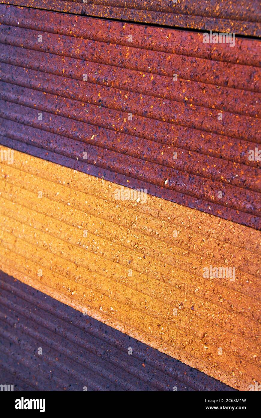 View from a side angle of bricks side by side - on a wall. The front of ...