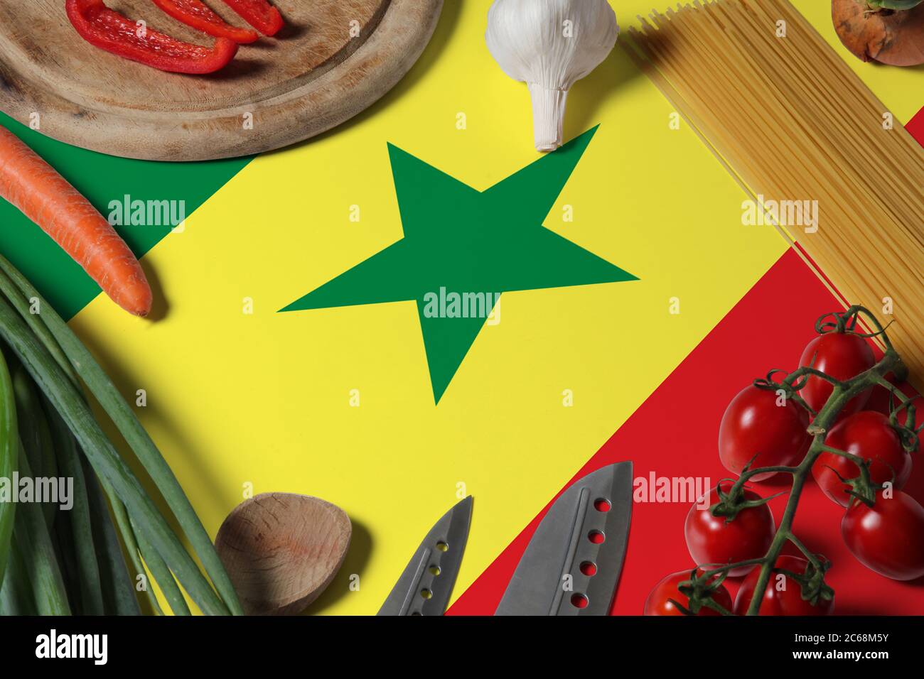 Senegal flag on fresh vegetables and knife concept wooden table ...