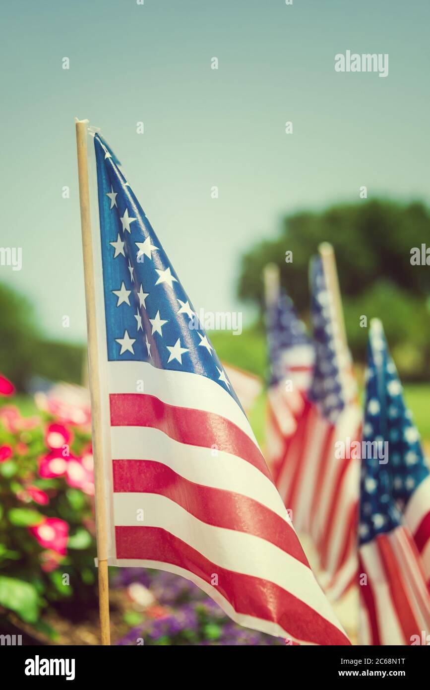 American flags displayed on the side of the street in honor of the 4th ...