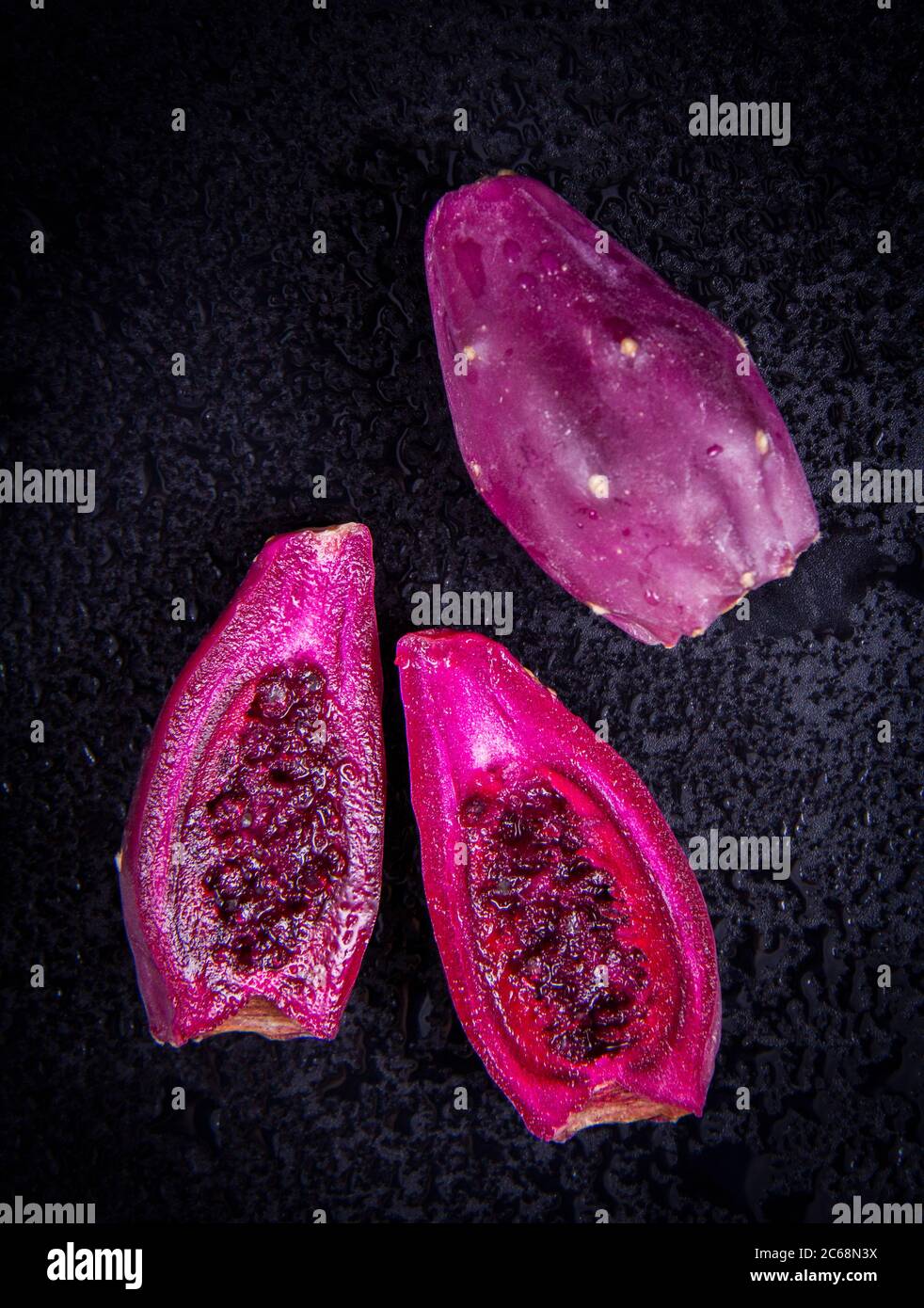 Chopped and peeled Barbary fig fruits on a black background Stock Photo ...