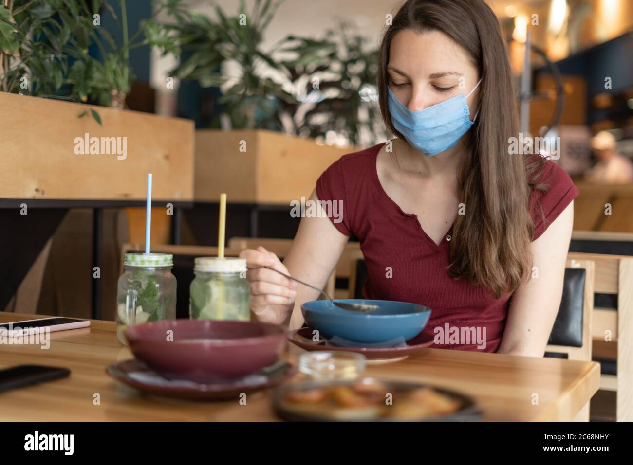 New normal concept of woman with mask eating in restaurant Stock Photo ...