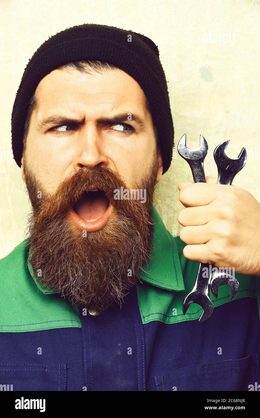 Bearded man, long beard. Brutal caucasian mechanic, surprised unshaven ...