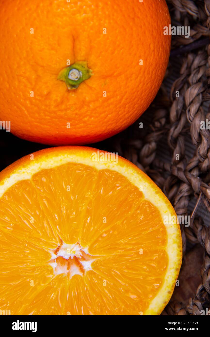 A designed photography of a full and half ripe orange Stock Photo - Alamy