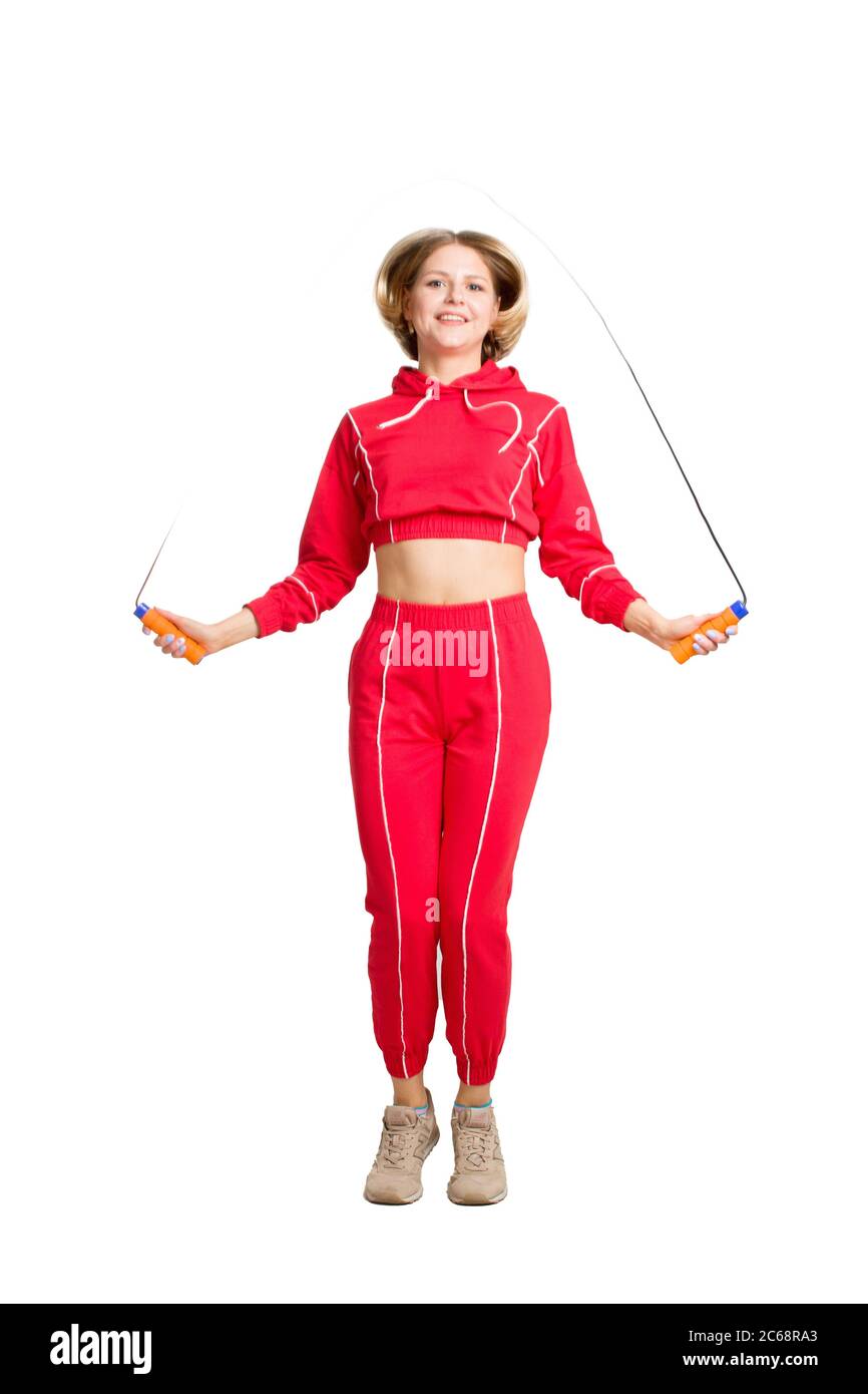 Young Fitness woman in red training dress. Jump a rope. Isolate on ...