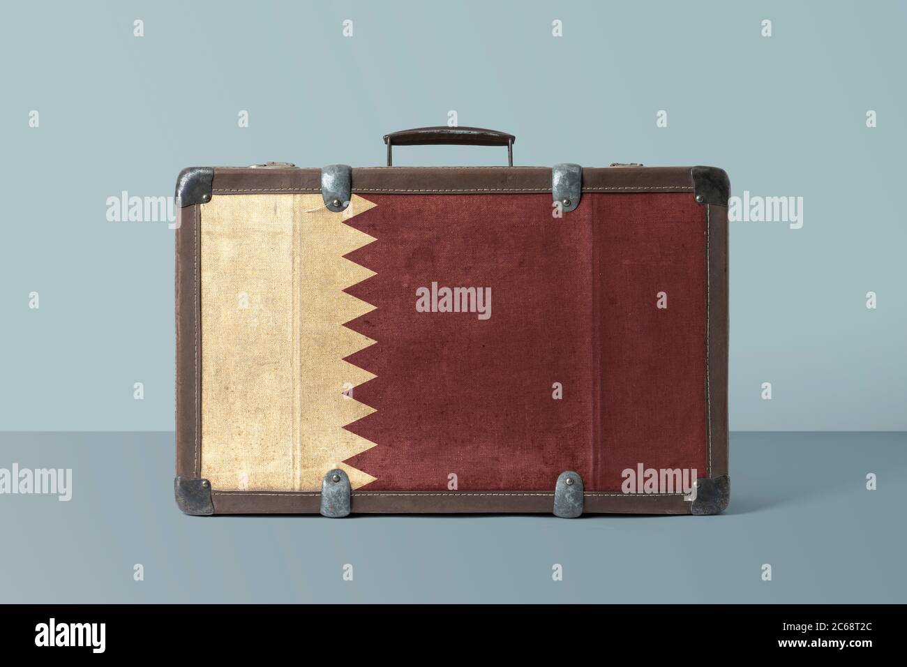 Qatar flag on old vintage leather suitcase with national concept. Retro ...