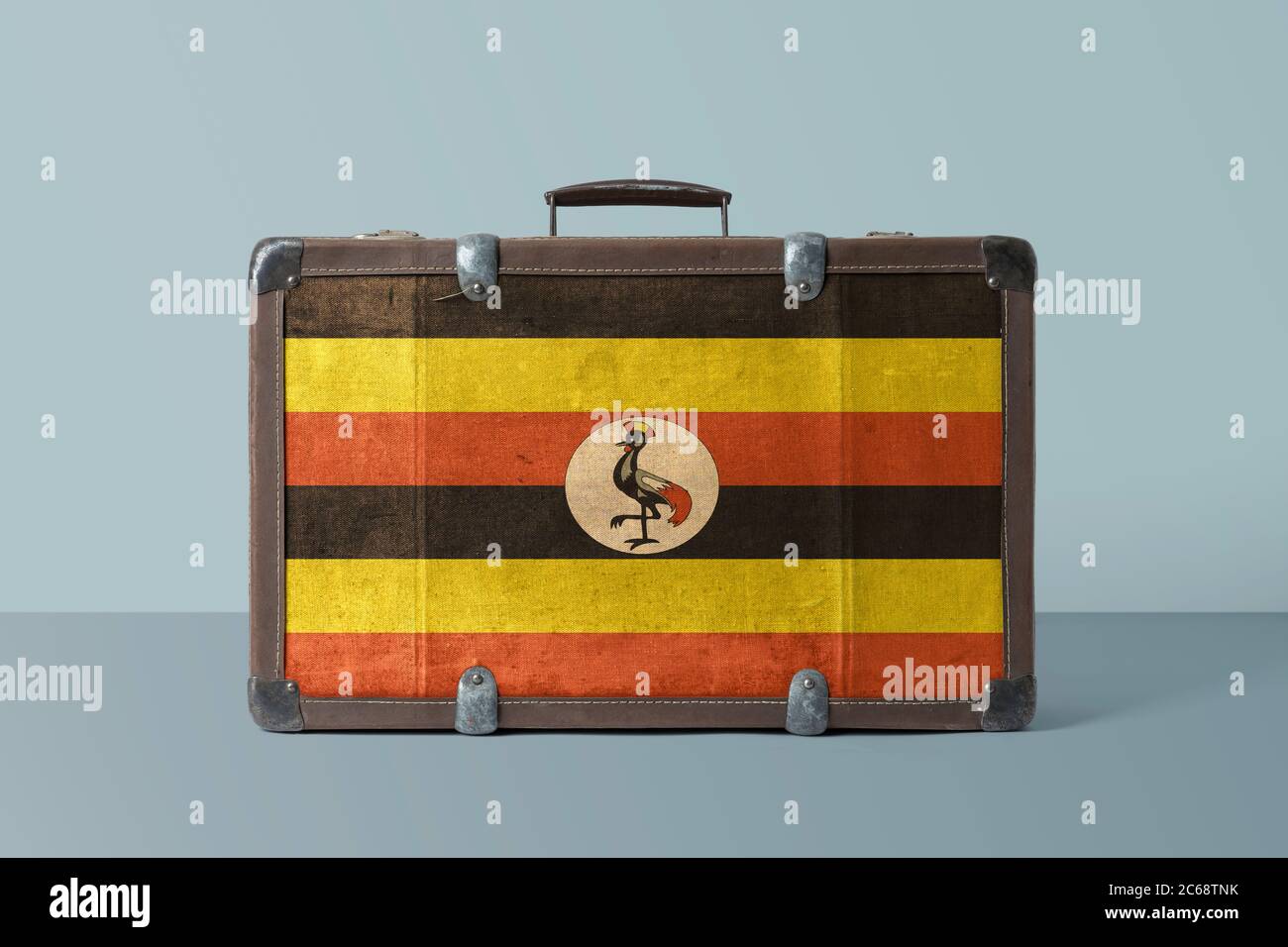 Uganda flag on old vintage leather suitcase with national concept ...