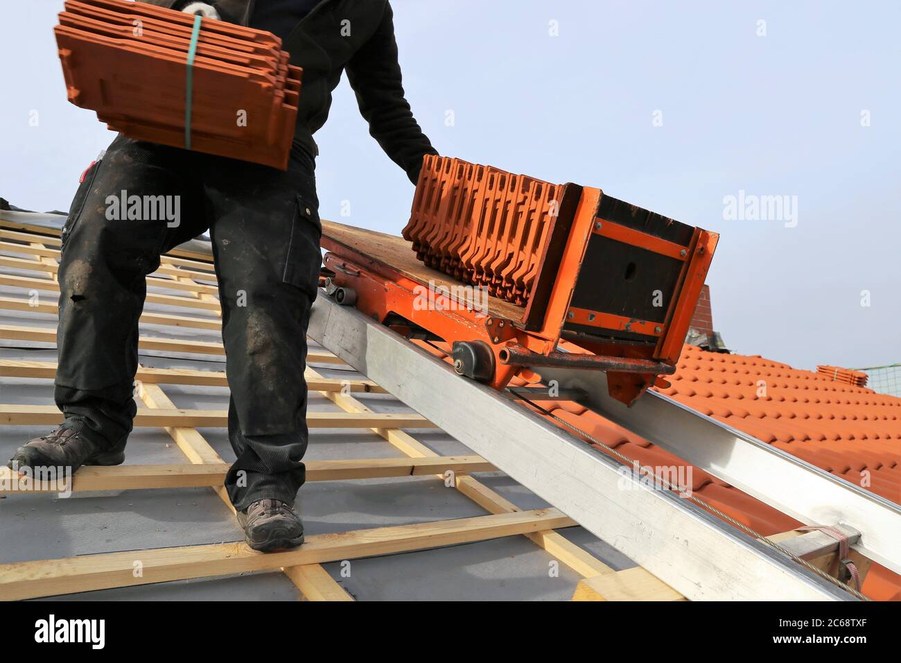 Roofing work, new covering of a tiled roof Stock Photo - Alamy