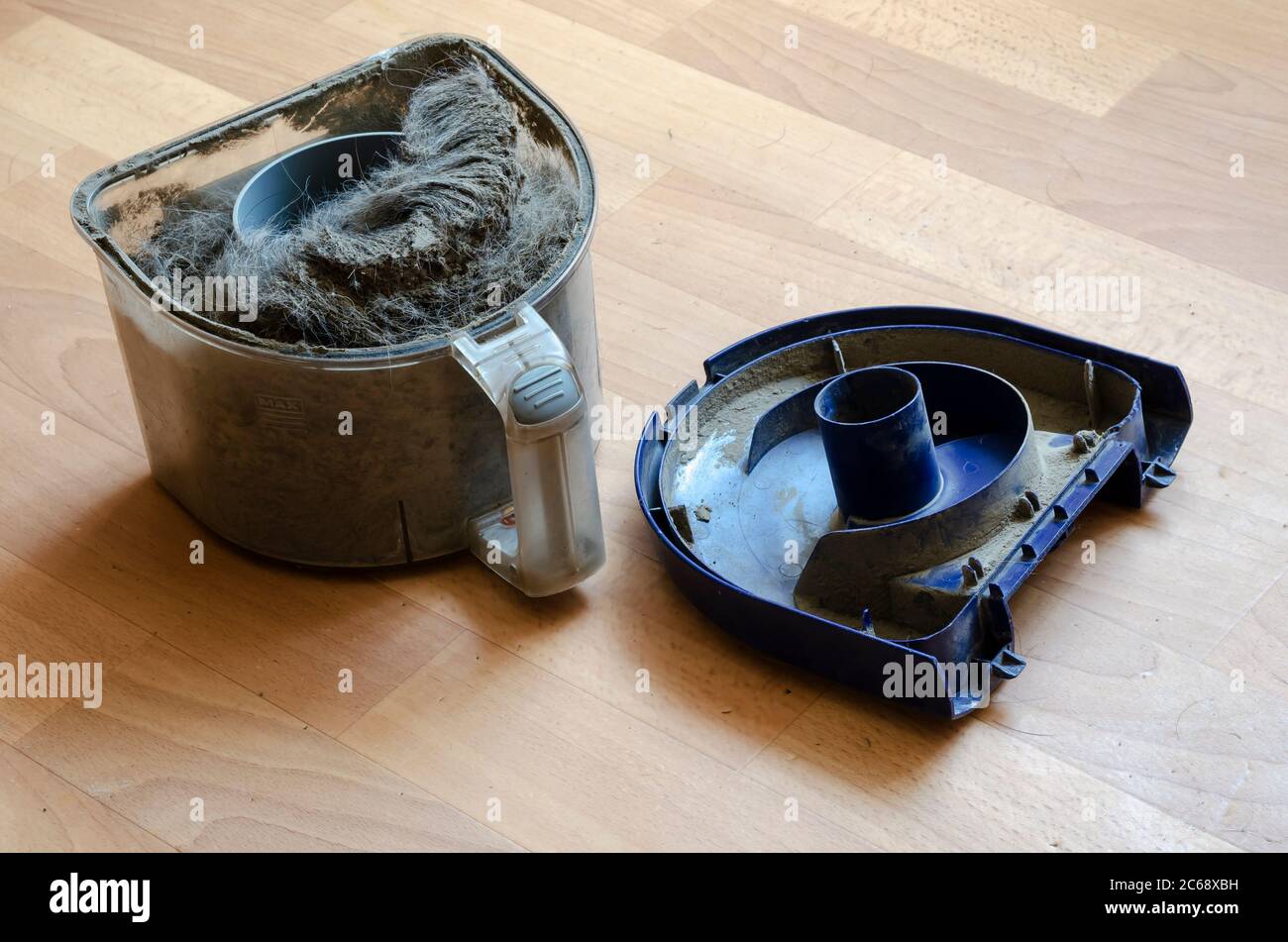 Vacuum cleaner container with garbage. A plastic waste container full ...