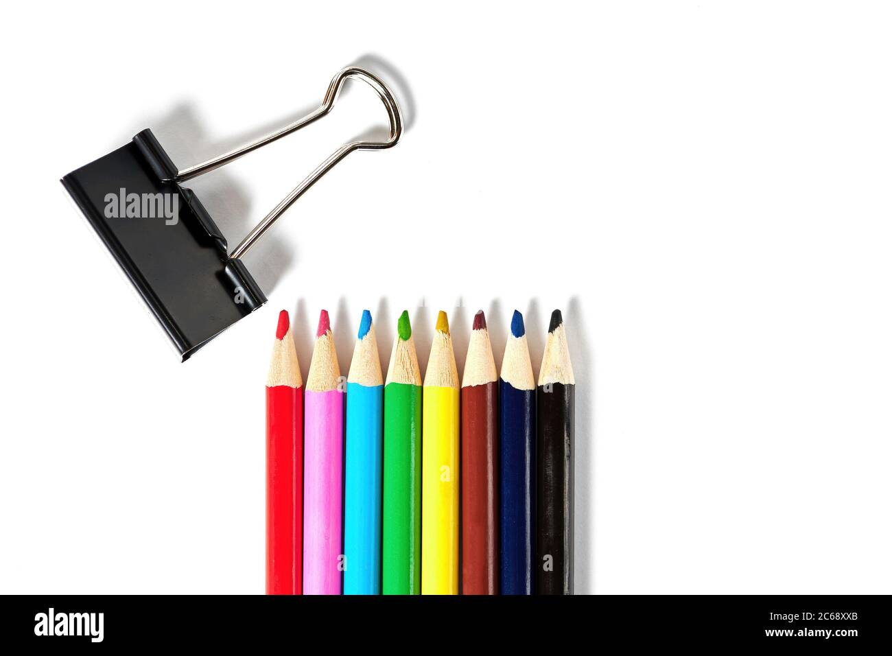 Rainbow colored pencils and paper clips isolated on the white ...